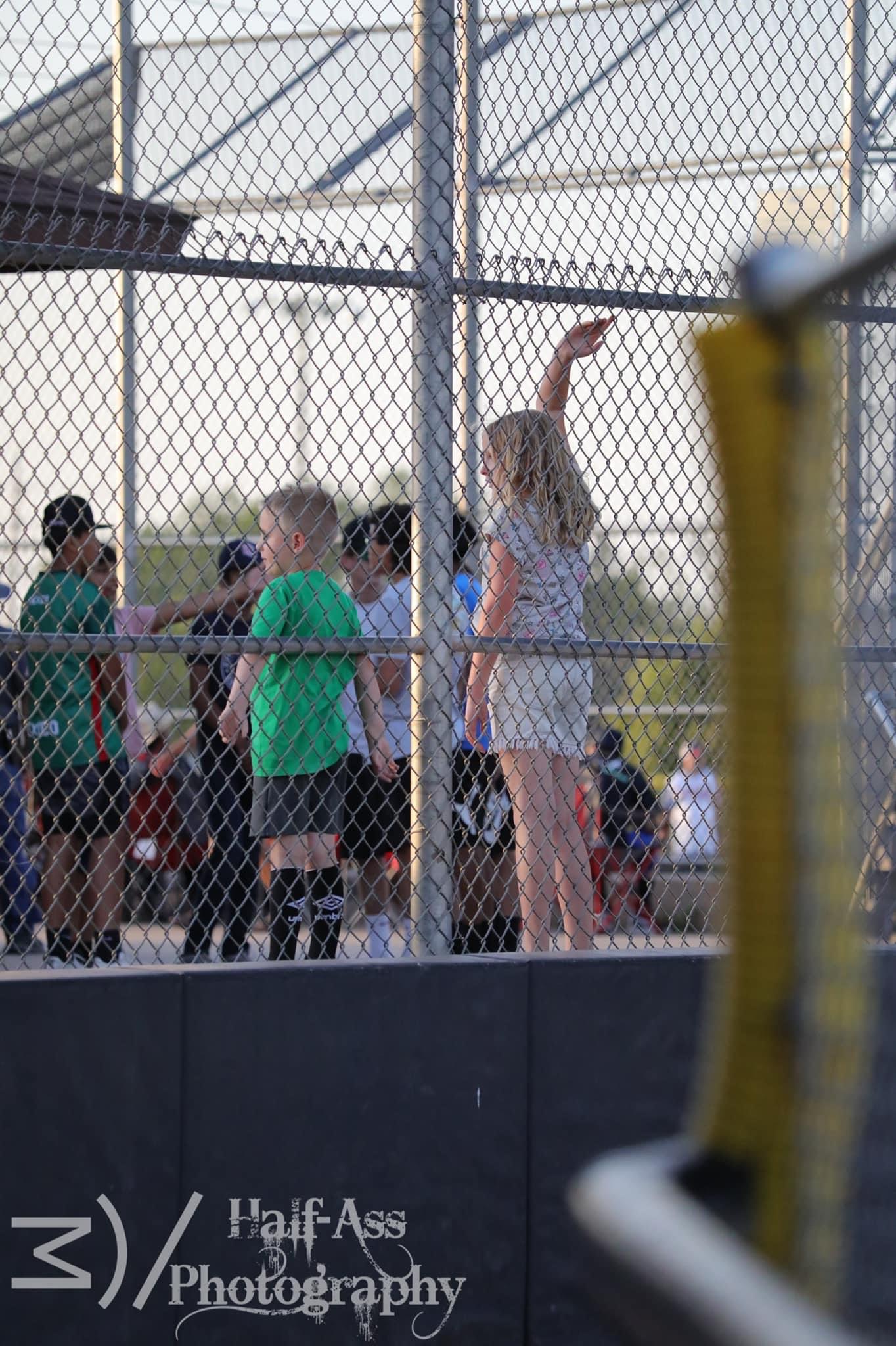 kids watching on the fence | CAFmedia